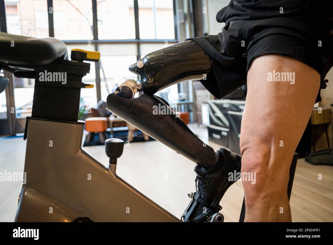 Man with amputated leg sitting on exercise bike in gym Stock Photo - Alamy