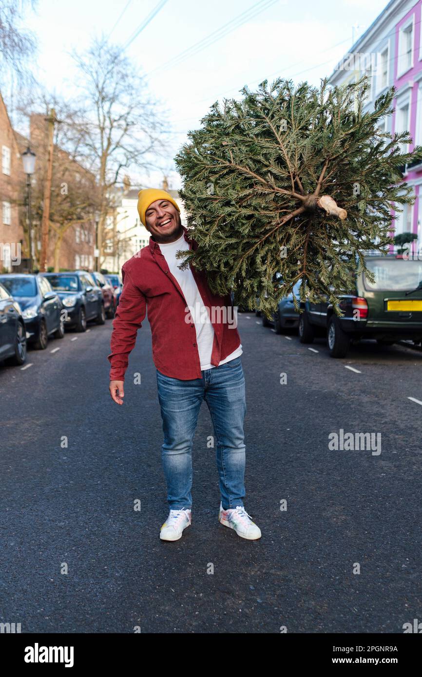 Man carrying plant street hi-res stock photography and images - Alamy