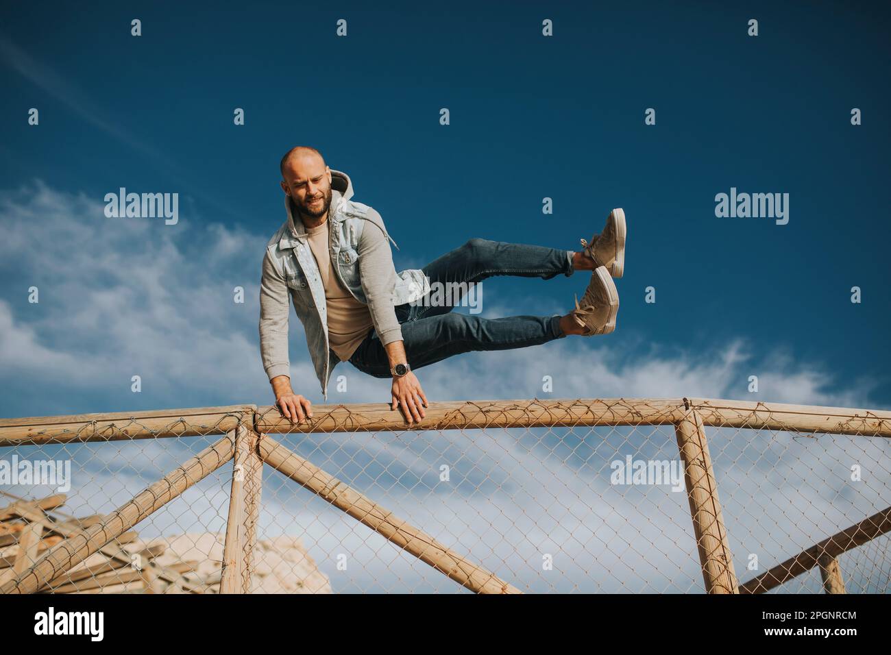 Man jumping over fence under sky Stock Photo - Alamy Man jumping over fence under sky Stock Photo - Alamy