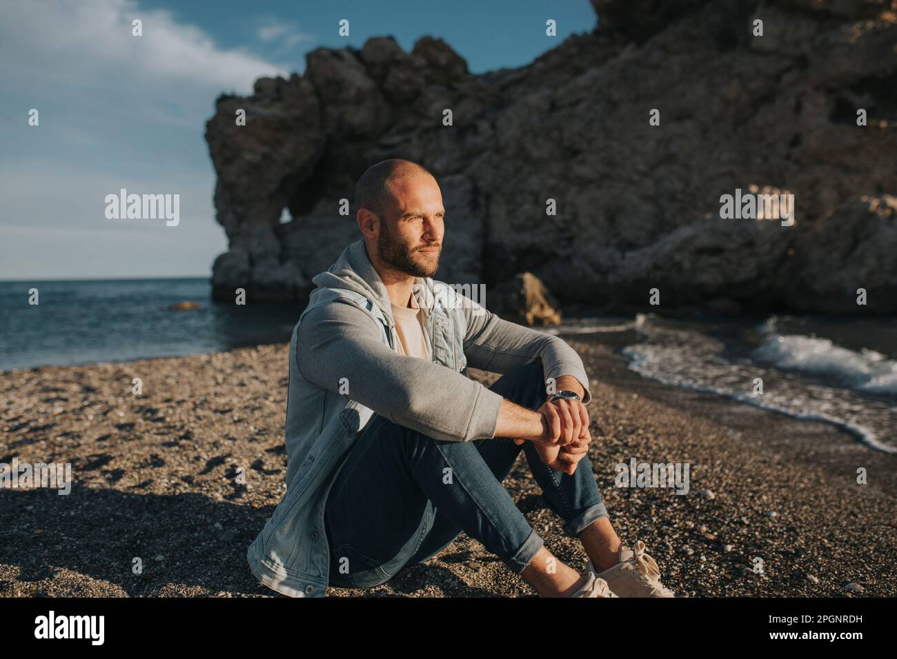 Pensive man sitting on beach hi-res stock photography and images - Alamy