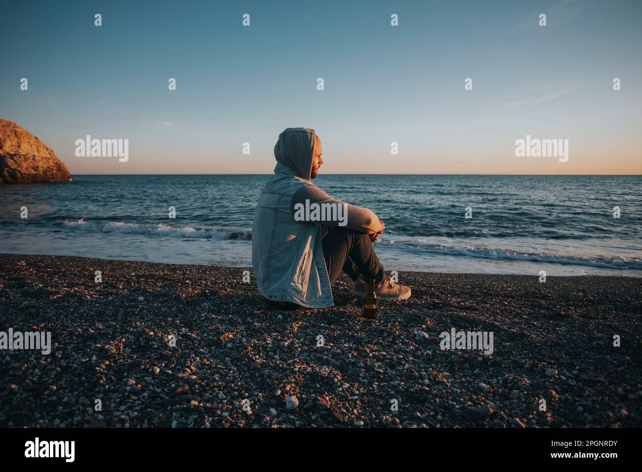 Pensive man sitting on beach hi-res stock photography and images - Alamy