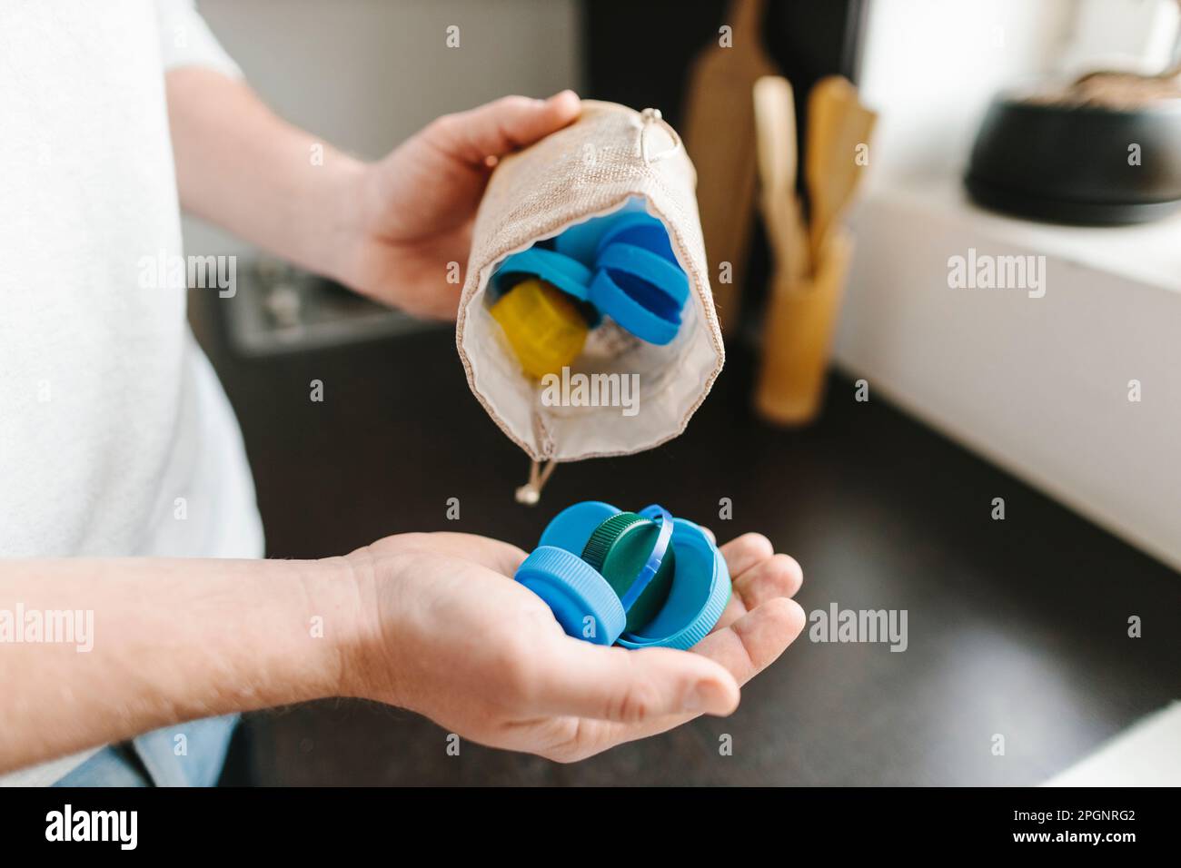 Plastic bottle caps hand hi-res stock photography and images - Alamy
