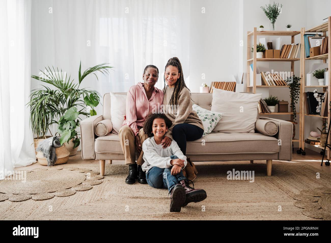 Family sitting together in living room at home Stock Photo - Alamy