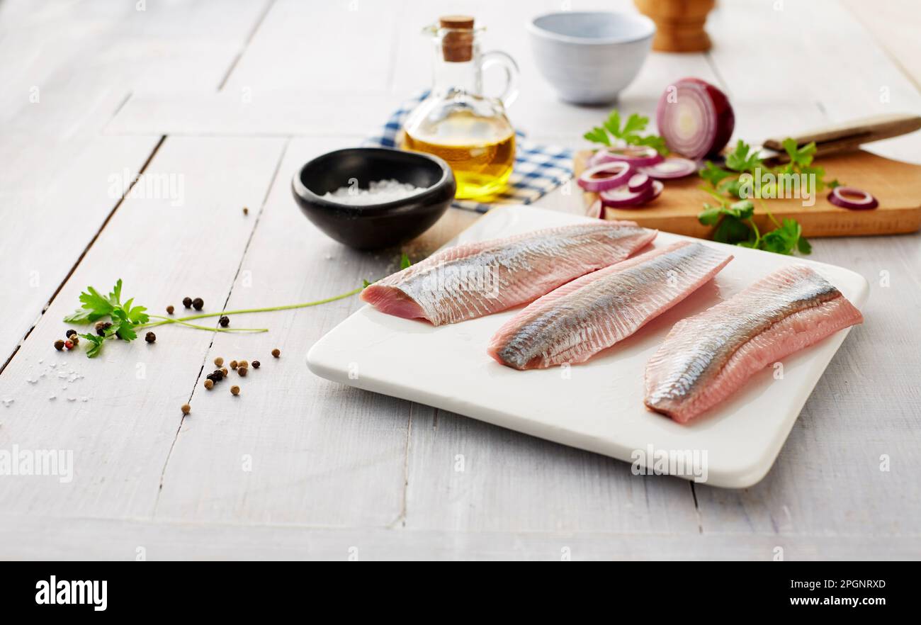 Preparation of three herring fillets Stock Photo - Alamy