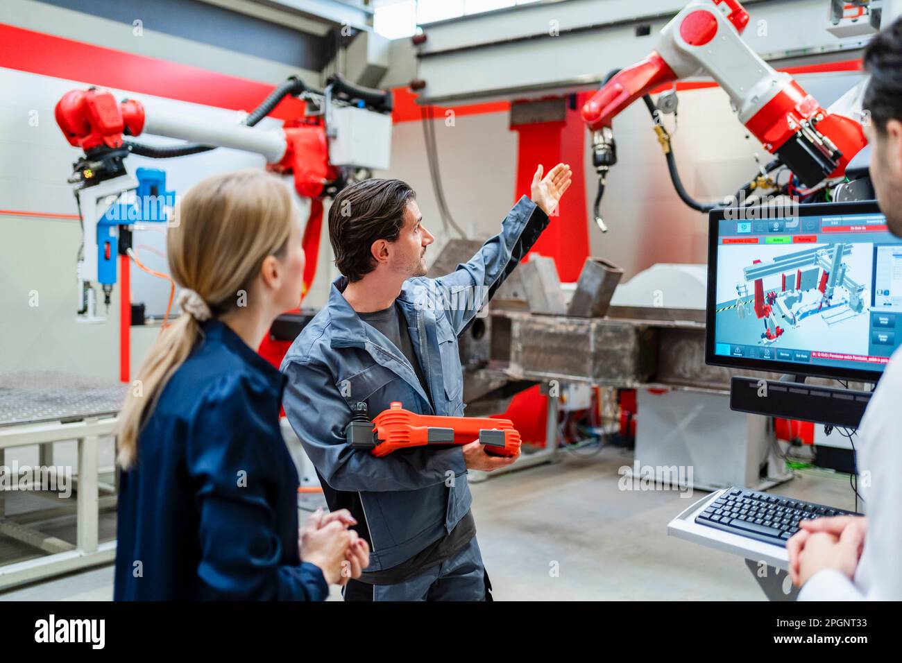 Engineer showing robots to colleagues in meeting at industry Stock Photo - Alamy
