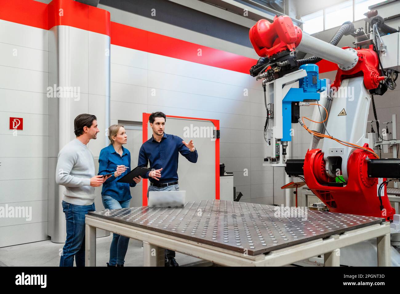 Business colleagues examining robots in modern industry Stock Photo - Alamy