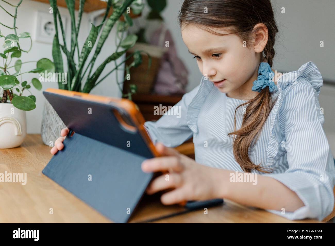 Cute girl in room with tablet hi-res stock photography and images - Alamy
