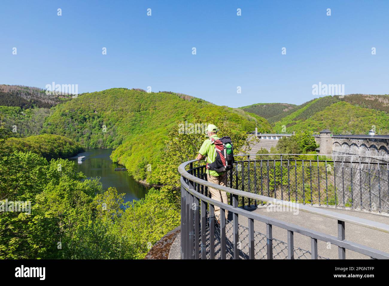 Germany, North Rhine Westphalia, Senior hiker looking toward Rursee ...