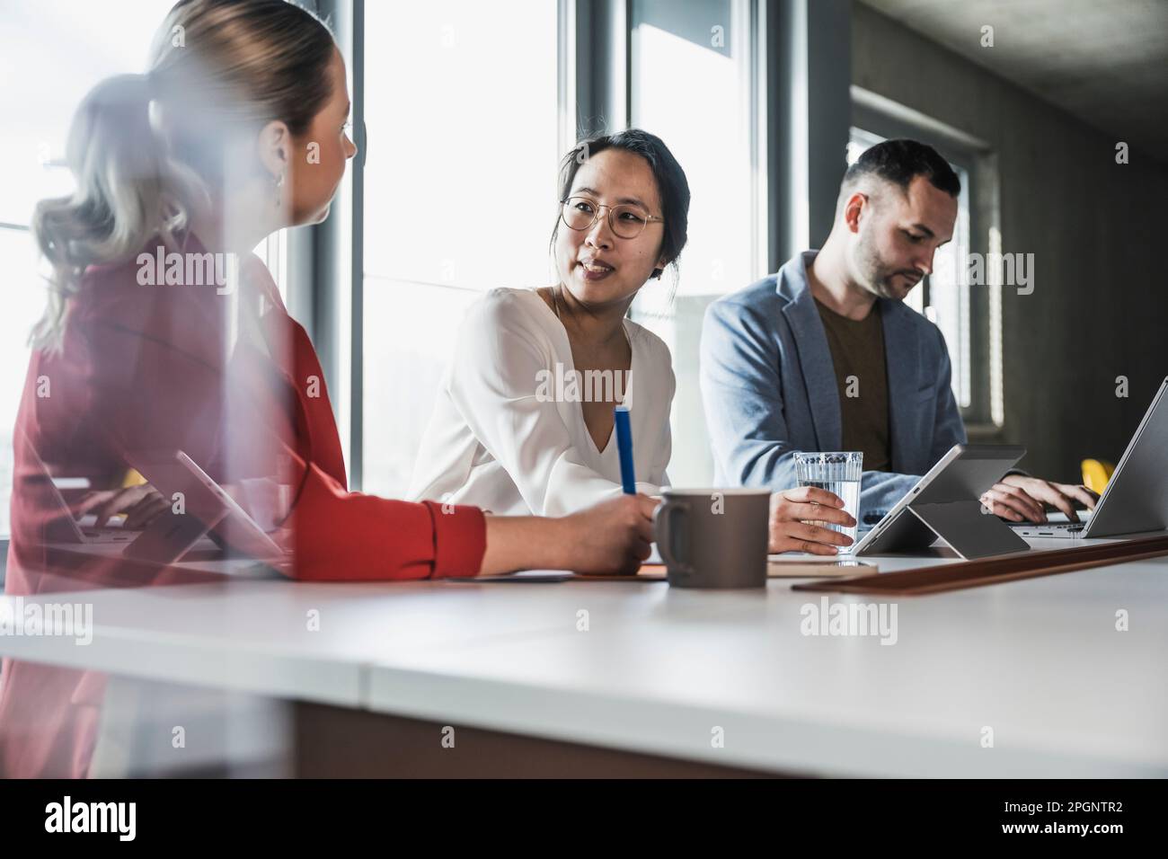 Businesswomen with colleague planning strategy at workplace Stock Photo ...