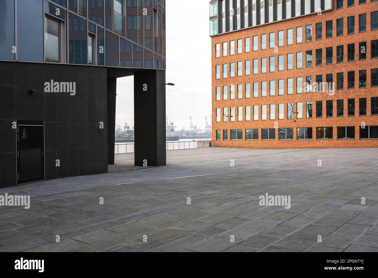 Germany, Hamburg, Empty pavement between two modern buildings Stock ...