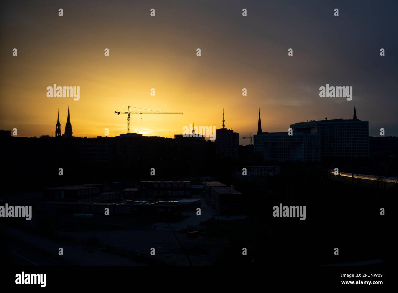 Silhouettes city spires construction crane sunset hi-res stock ...