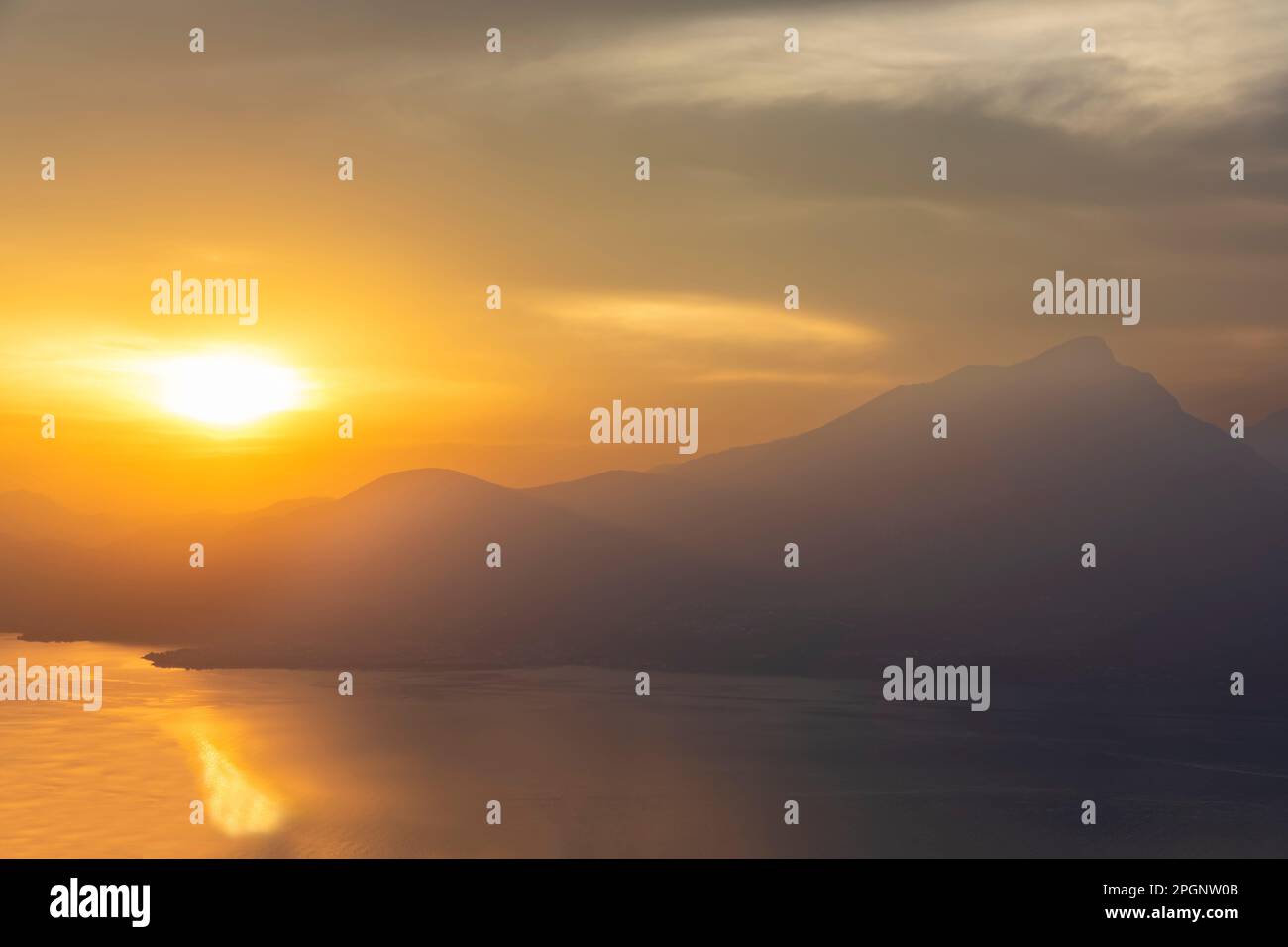 Italy, Veneto, San Zeno di Montagna, Lake Garda at cloudy sunset with ...