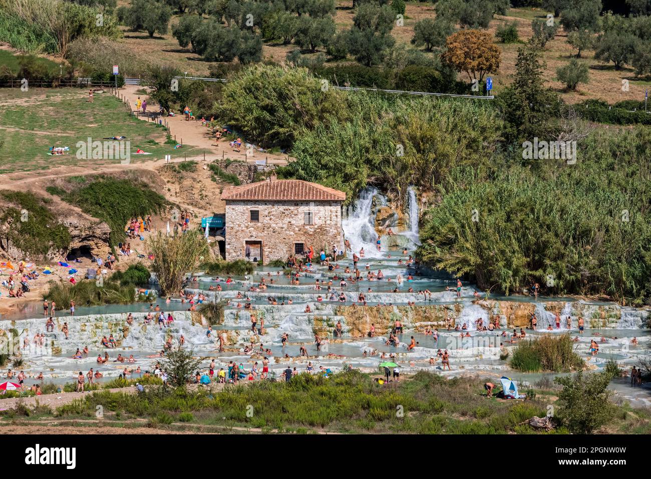 Italy, Tuscany, Saturnia, People bathing in Cascate del Mulino thermal ...