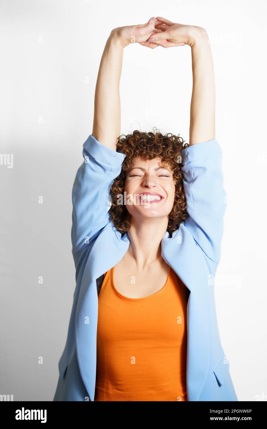 Happy woman stretching arms against white background Stock Photo - Alamy
