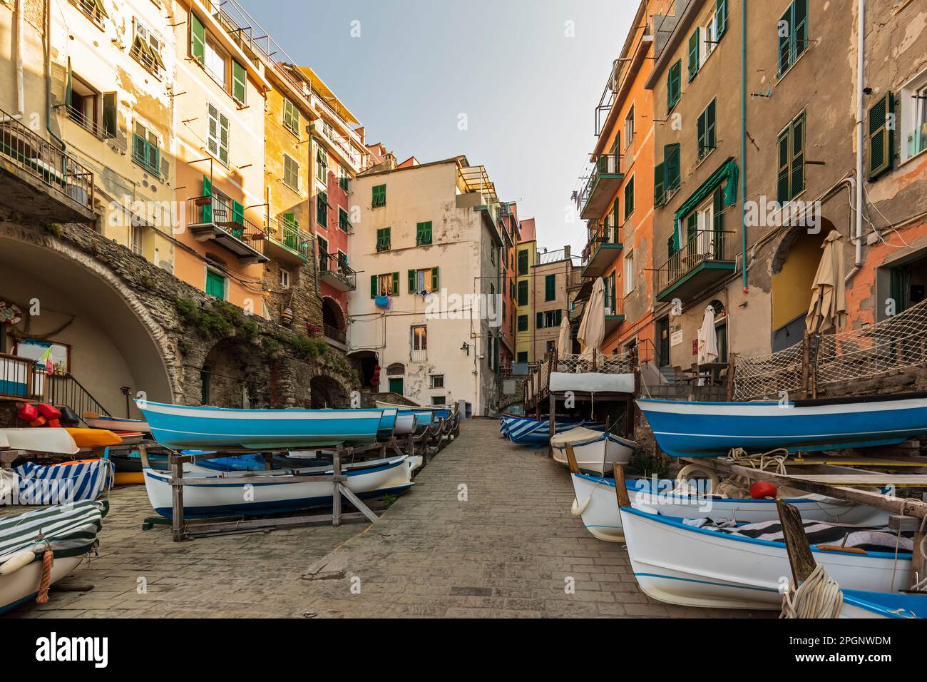 Boats lying along empty street coastal town along cinque terre hi-res ...