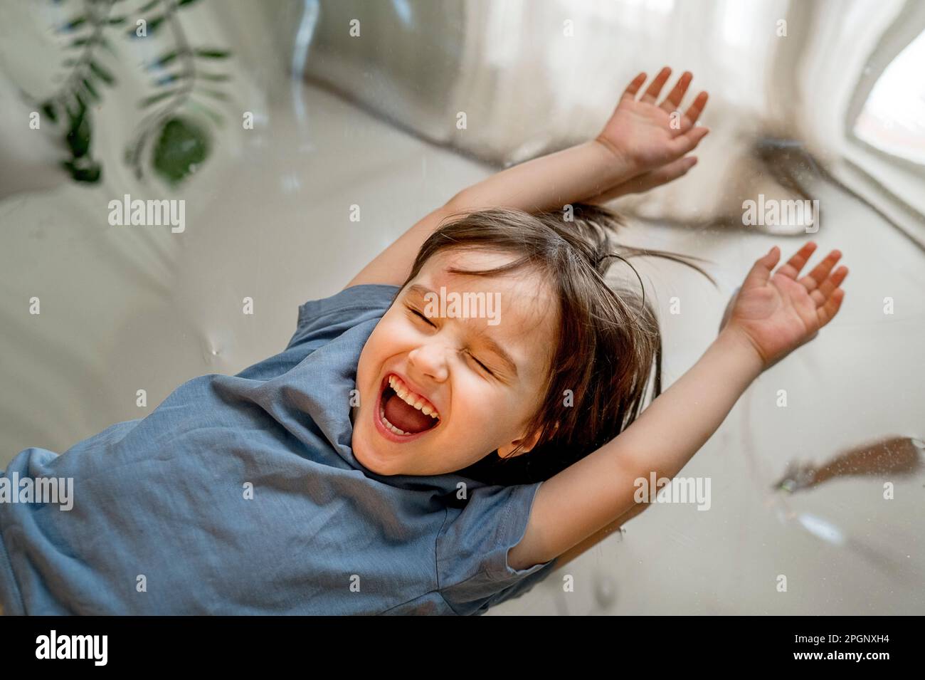 Cheerful boy lying on mirror Stock Photo - Alamy
