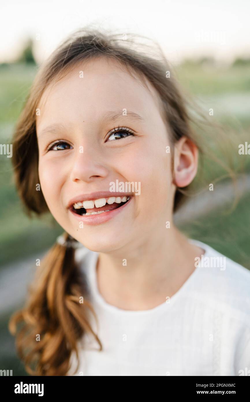 Happy cute girl in field Stock Photo - Alamy