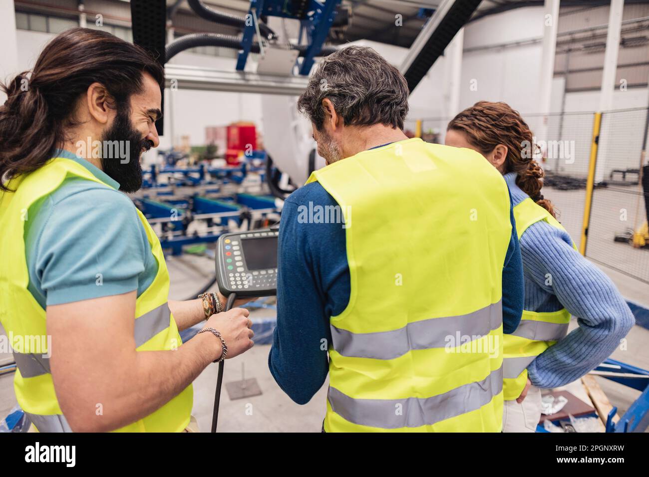 Engineers with control panel standing in factory Stock Photo - Alamy