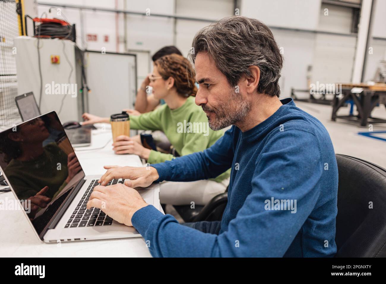 Working colleagues holding laptop hi-res stock photography and images ...