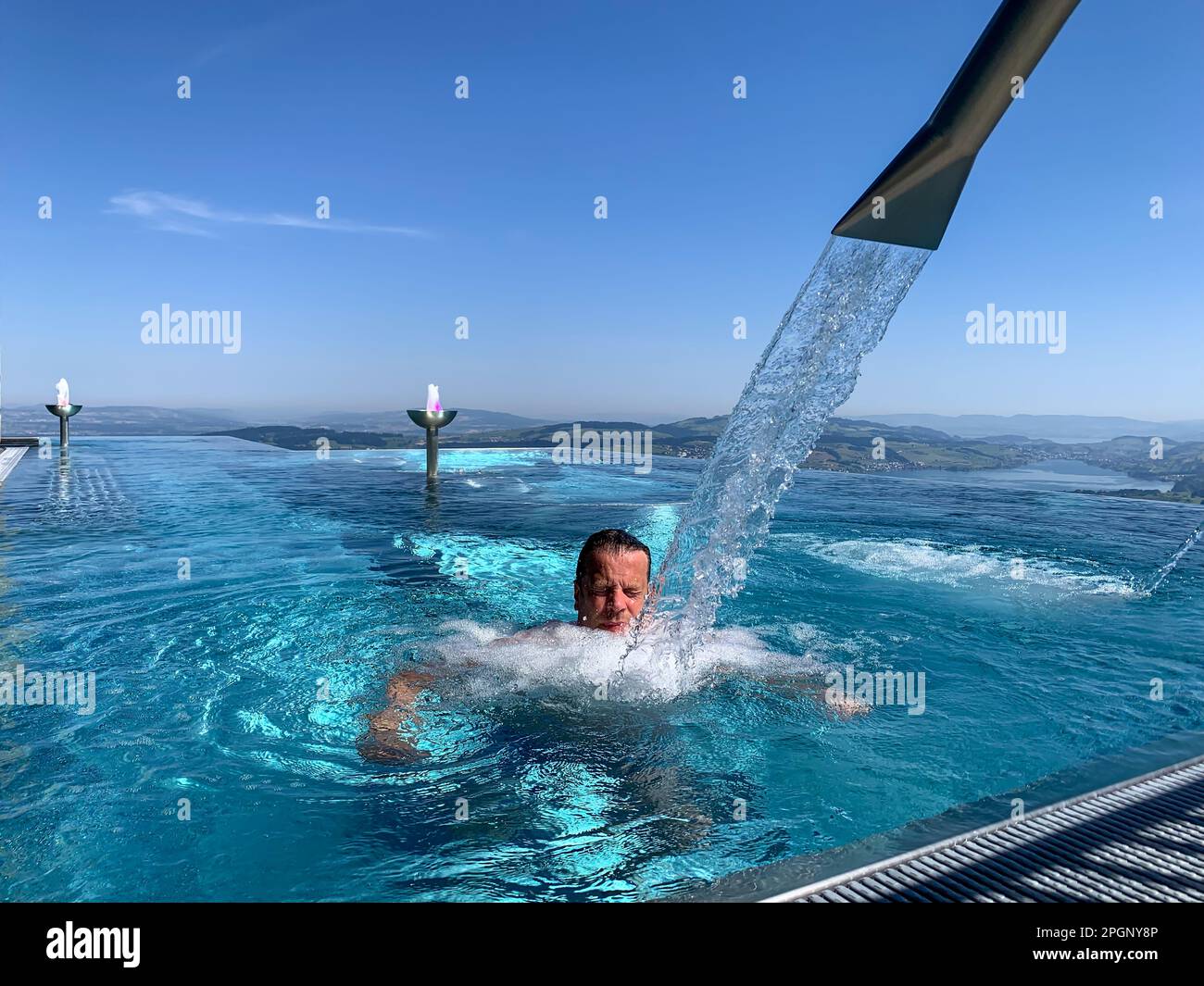 Man Enjoy Infinity Swimming Pool with Mountain and Lake Lucerne View in ...