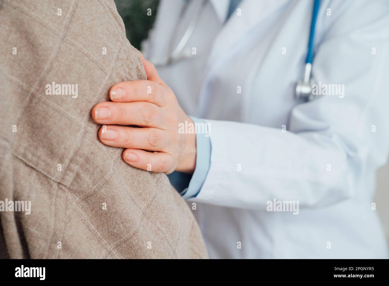 Doctor consoling female patient hi-res stock photography and images - Alamy