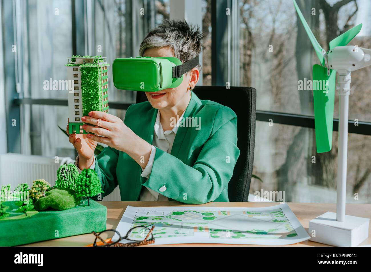 Businesswoman wearing virtual reality simulator holding biophilic ...