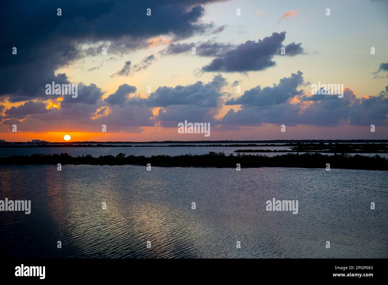 Sunset in San Pedro bay in Belize with the sun setting Stock Photo - Alamy
