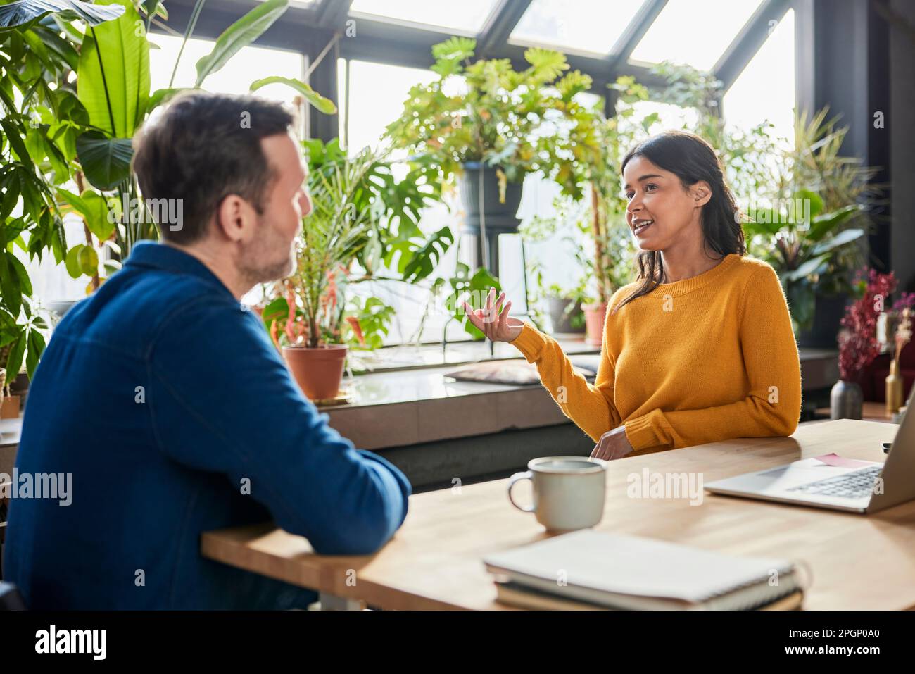 Business colleagues discussing with each other in meeting at loft ...