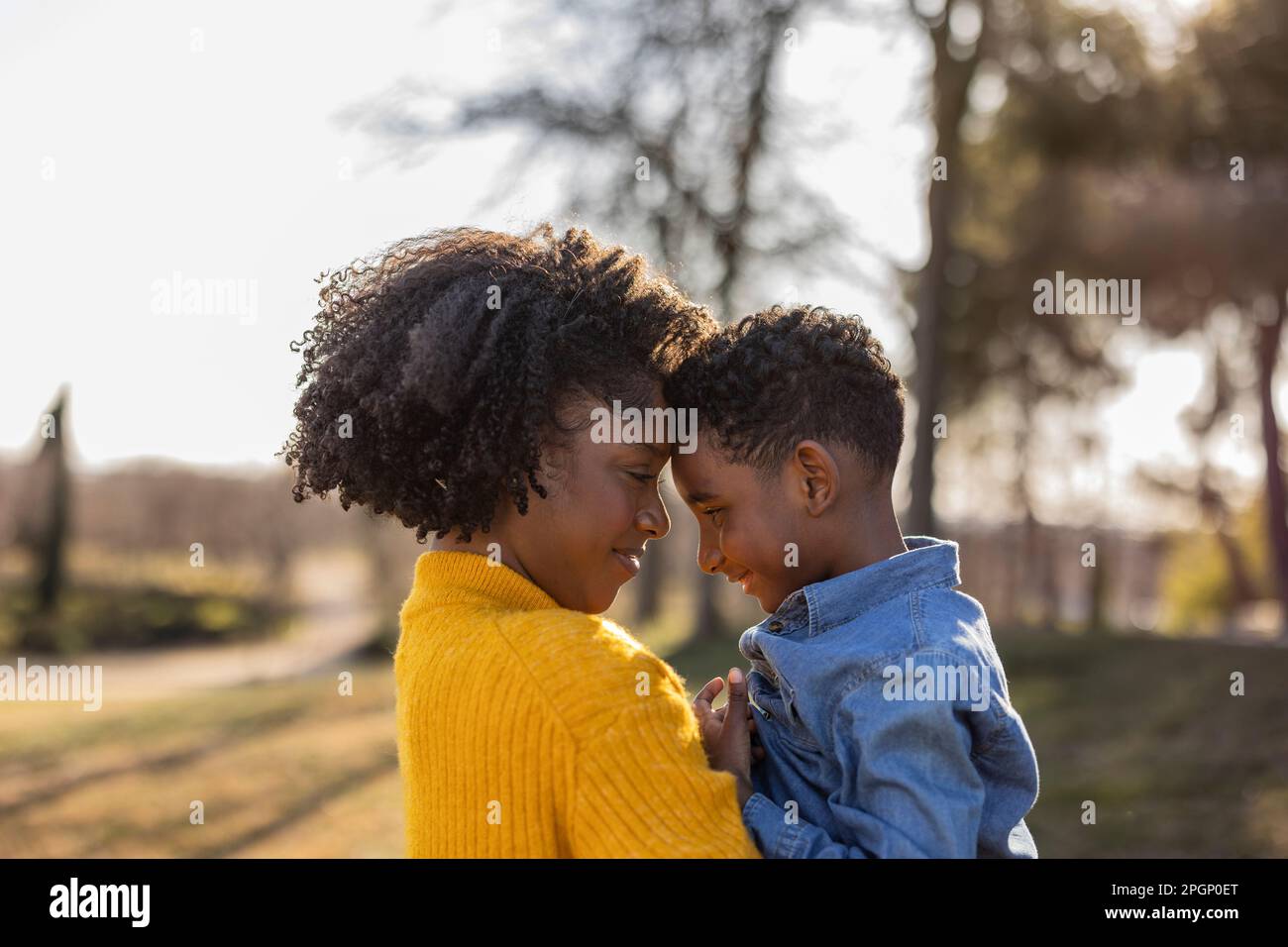 Mother and son touching foreheads in park Stock Photo - Alamy