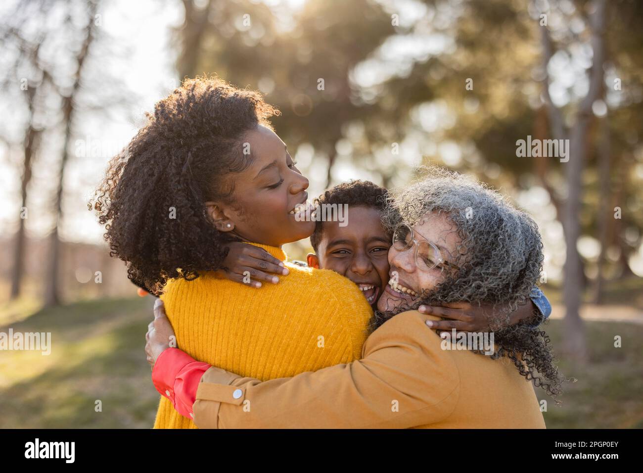 Happy multi-generation family embracing and having fun in park Stock ...