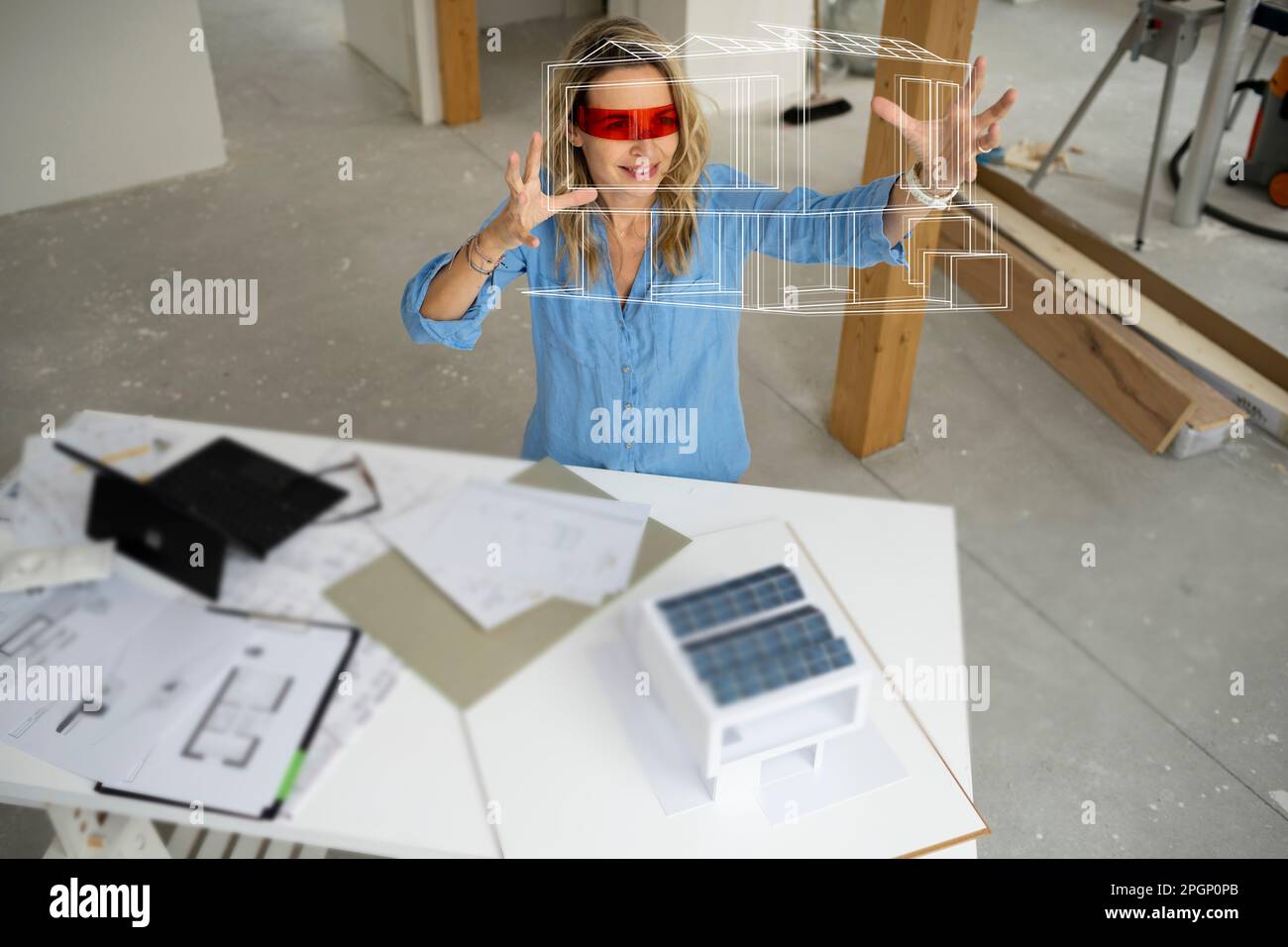 Smiling architect wearing virtual reality simulator gesturing and ...