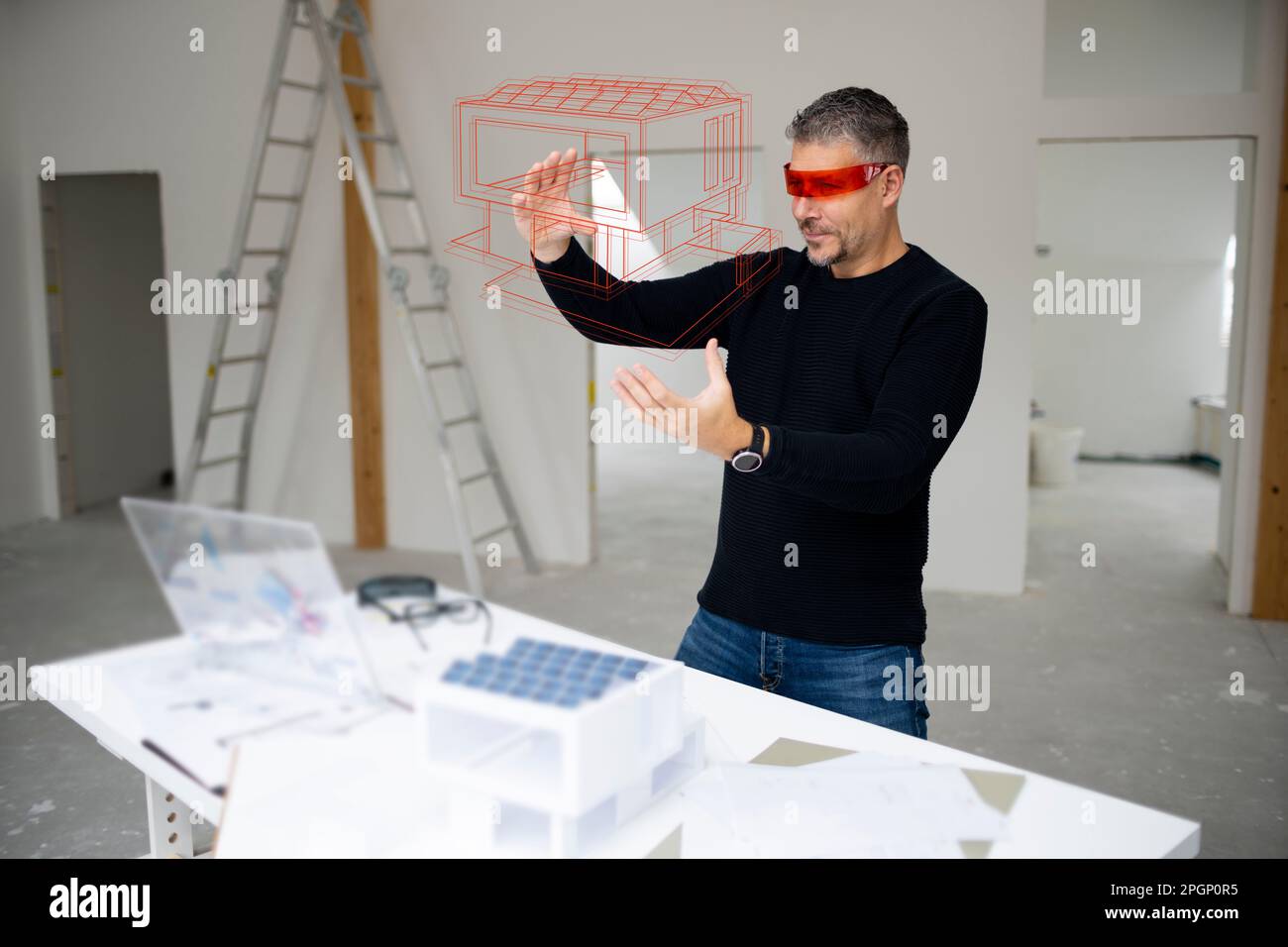 Architect wearing virtual reality simulator examining house model and ...
