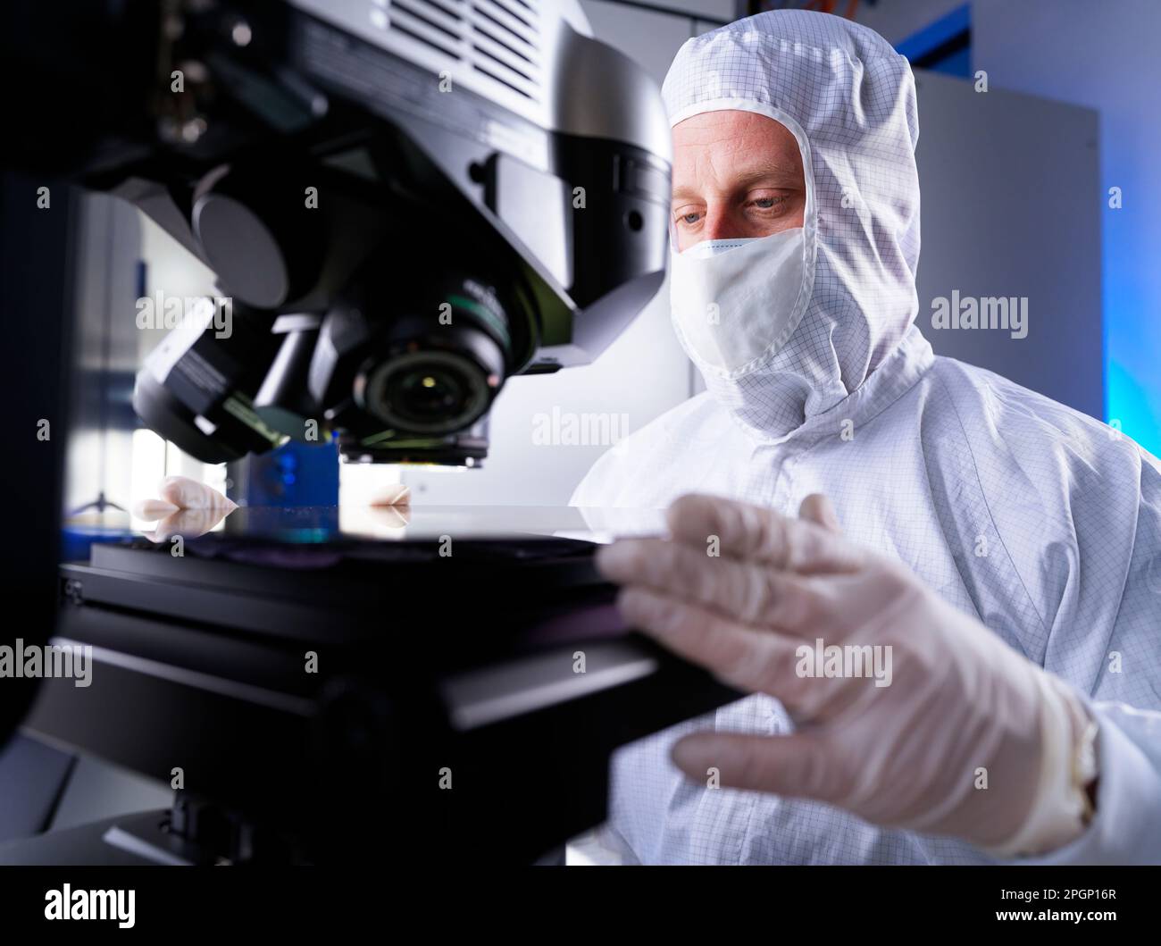 Engineer checking silicon wafer chip using semiconductor in laboratory ...