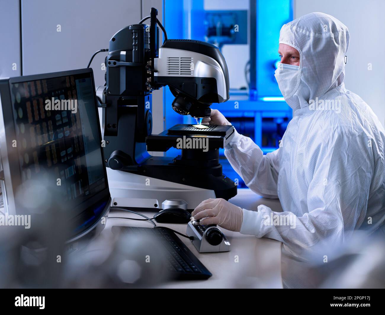 Engineer examining microscope in laboratory Stock Photo - Alamy