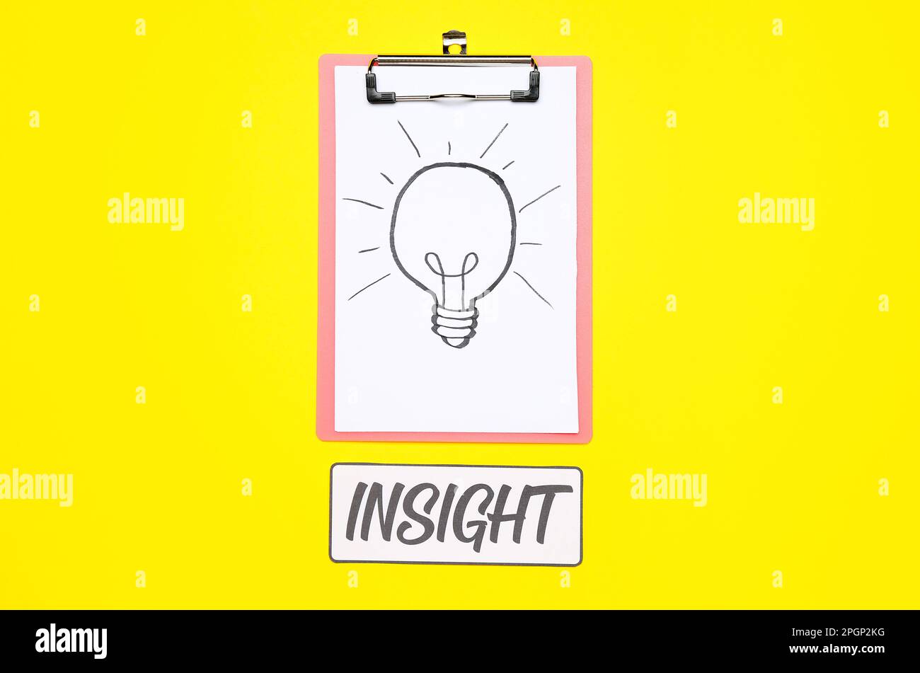 Clipboard with drawn light bulb and word INSIGHT on yellow background ...
