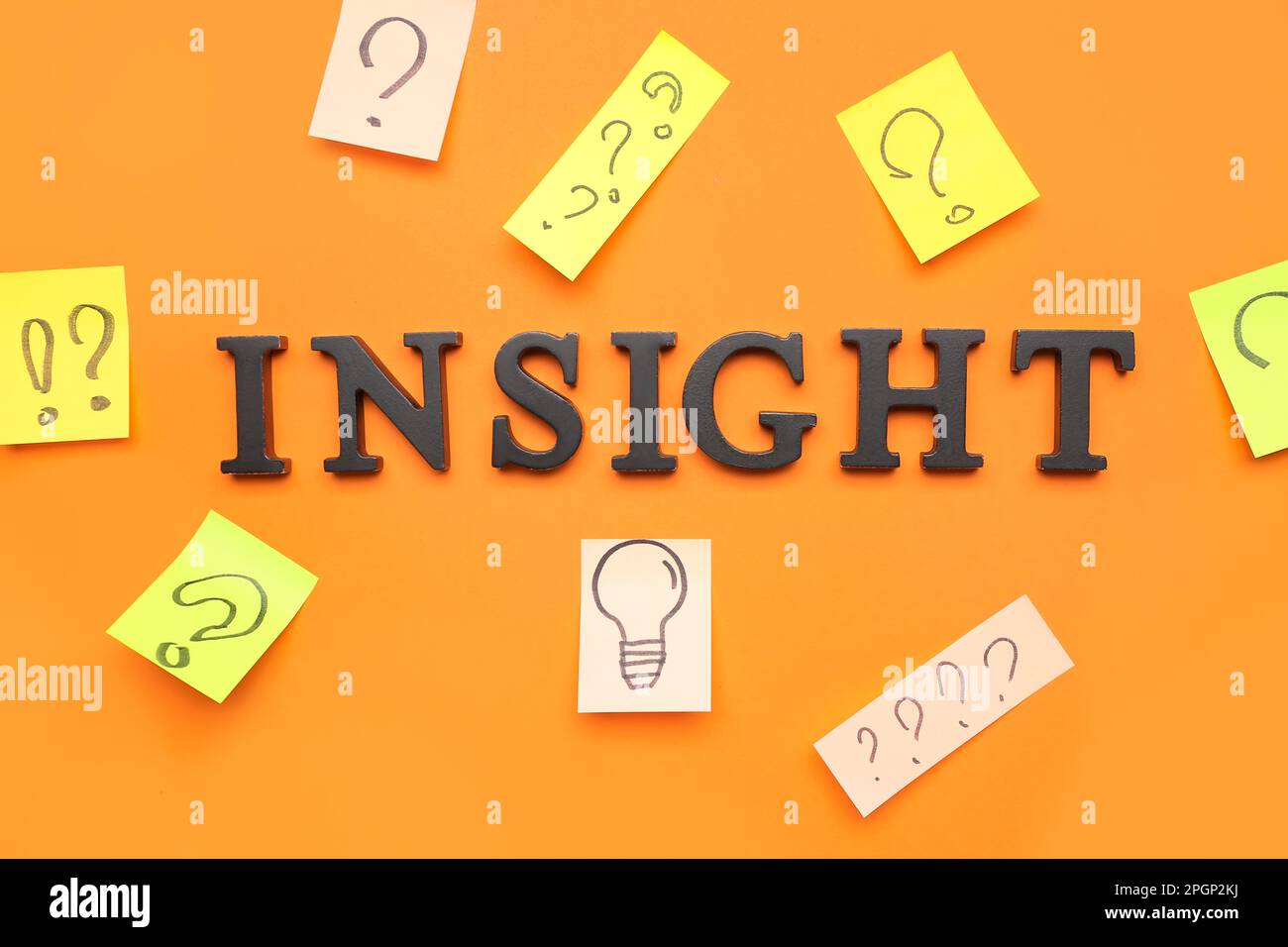 Word INSIGHT, papers with drawn question marks and light bulb on red ...