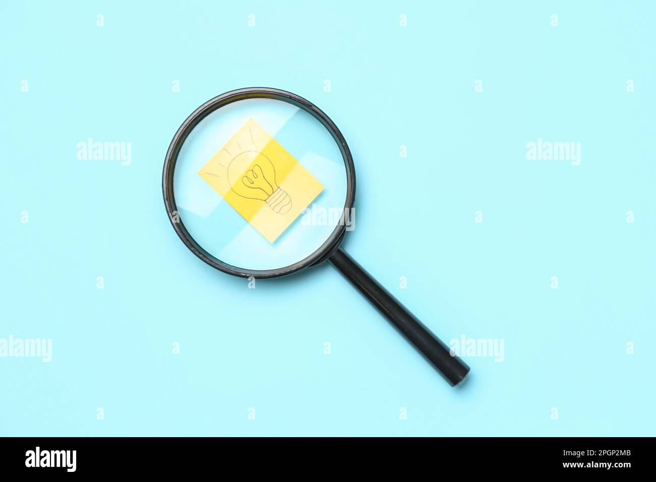 Paper with drawn light bulb and magnifier on blue background. Insight ...