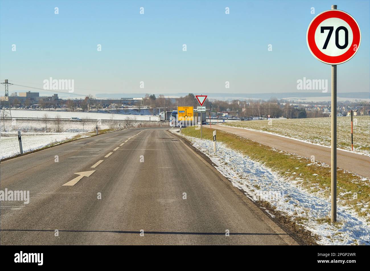 View of road with speed limit 70 sign on winter day Stock Photo - Alamy