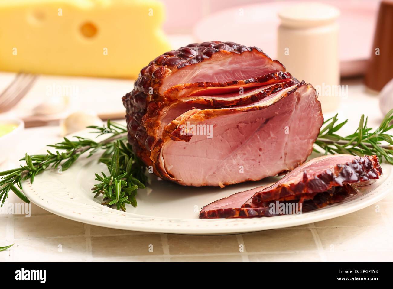 Plate with tasty smoked ham on light tile background Stock Photo - Alamy