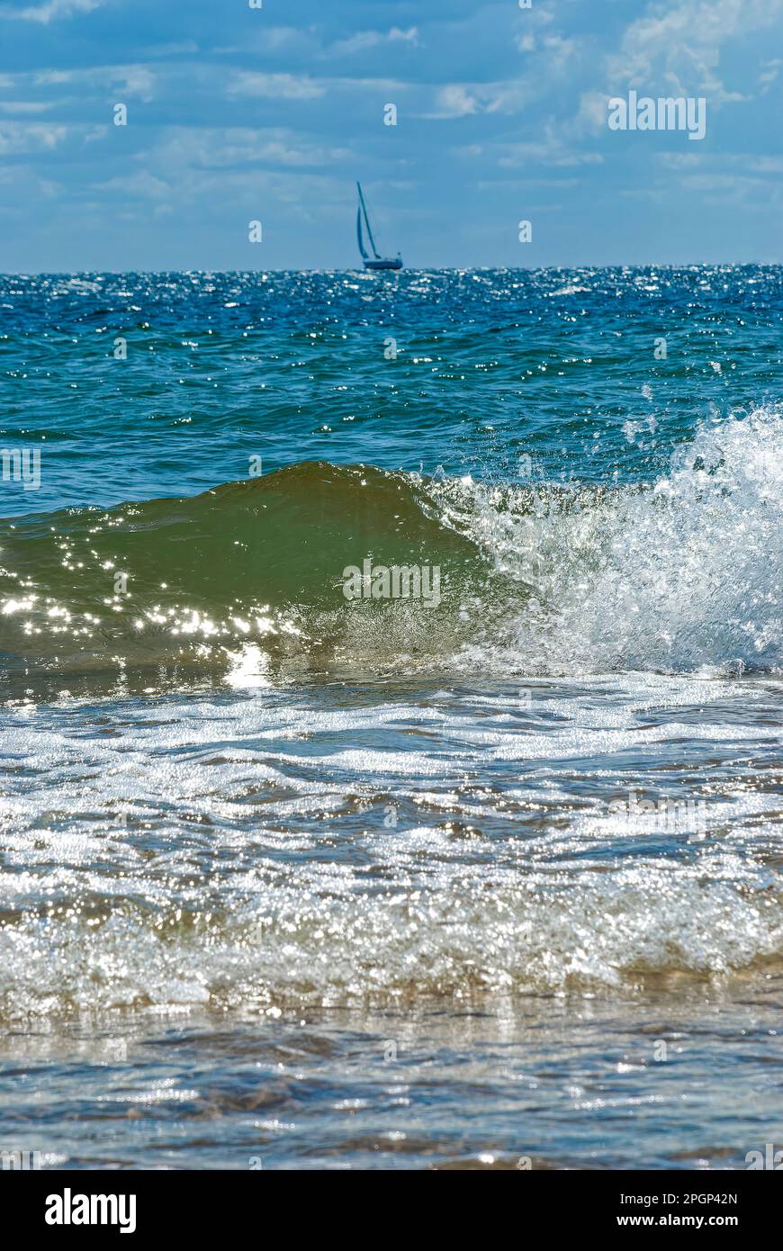 nautical background – splashing waves in the sun, blue sky above the ...