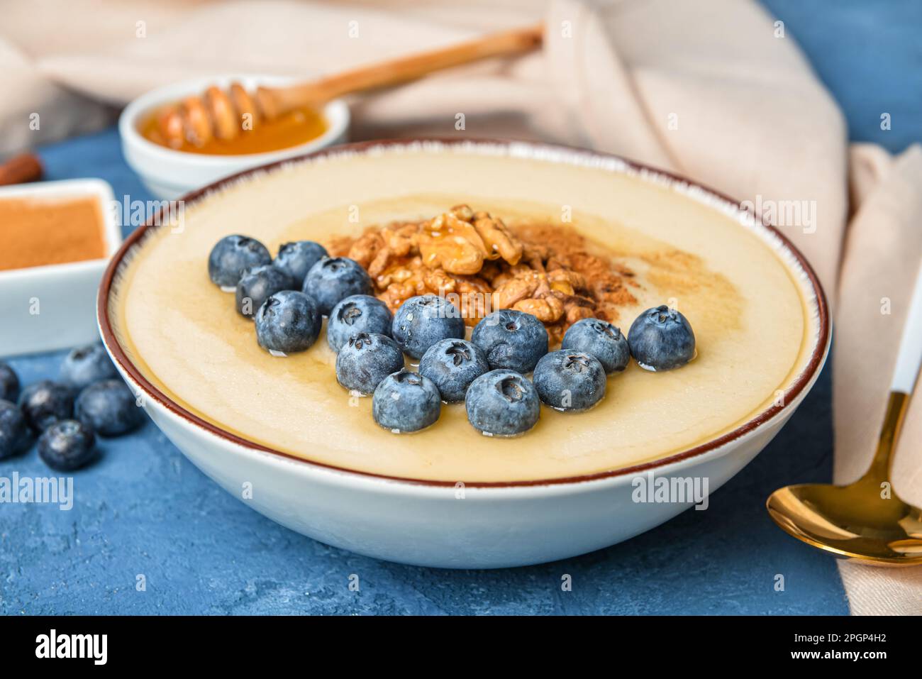 Bowl of tasty semolina porridge with blueberry, cinnamon, nuts and ...