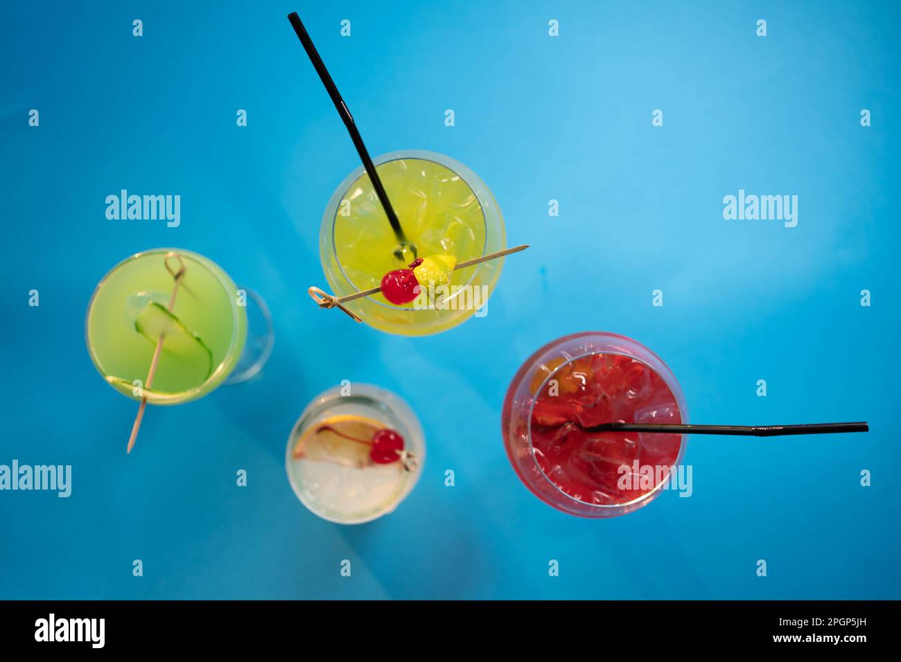 set of color alcohol stylish cocktails on blue background, green, red ...
