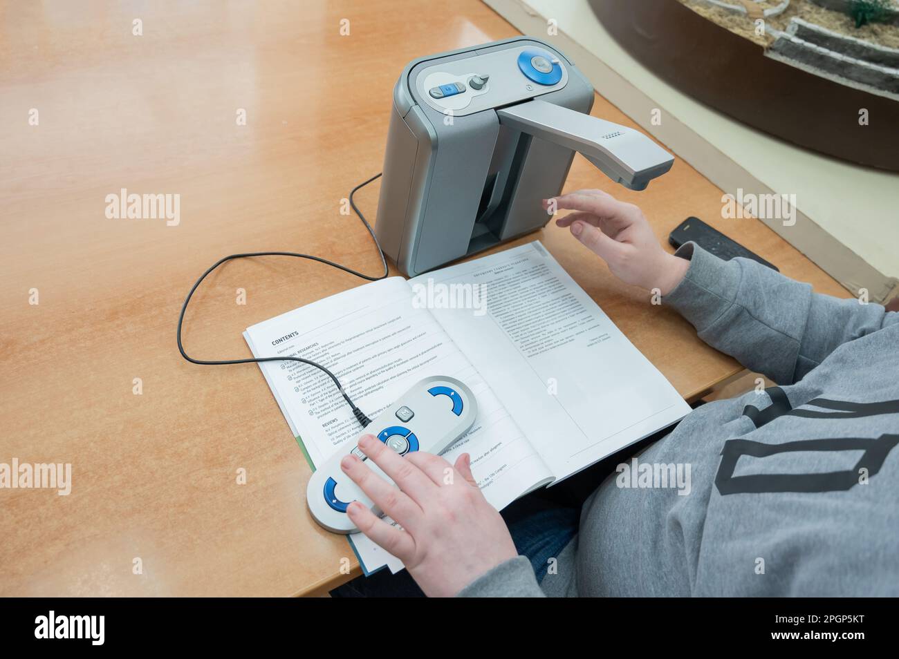 A visually impaired man uses a scanning and reading machine Stock Photo ...