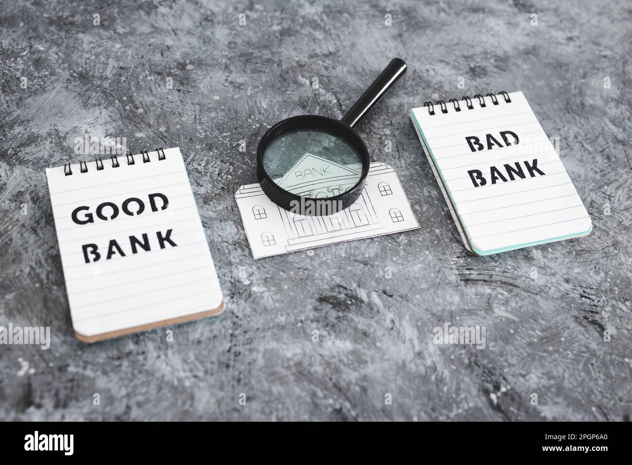 Good bank vs Bad Bank insolvency and closing down, bank with magnifying ...