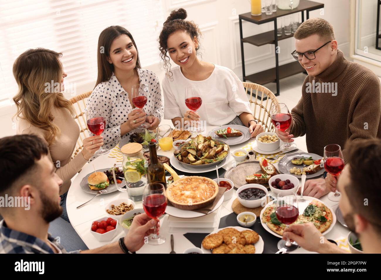 Group of people having brunch together at table indoors Stock Photo - Alamy