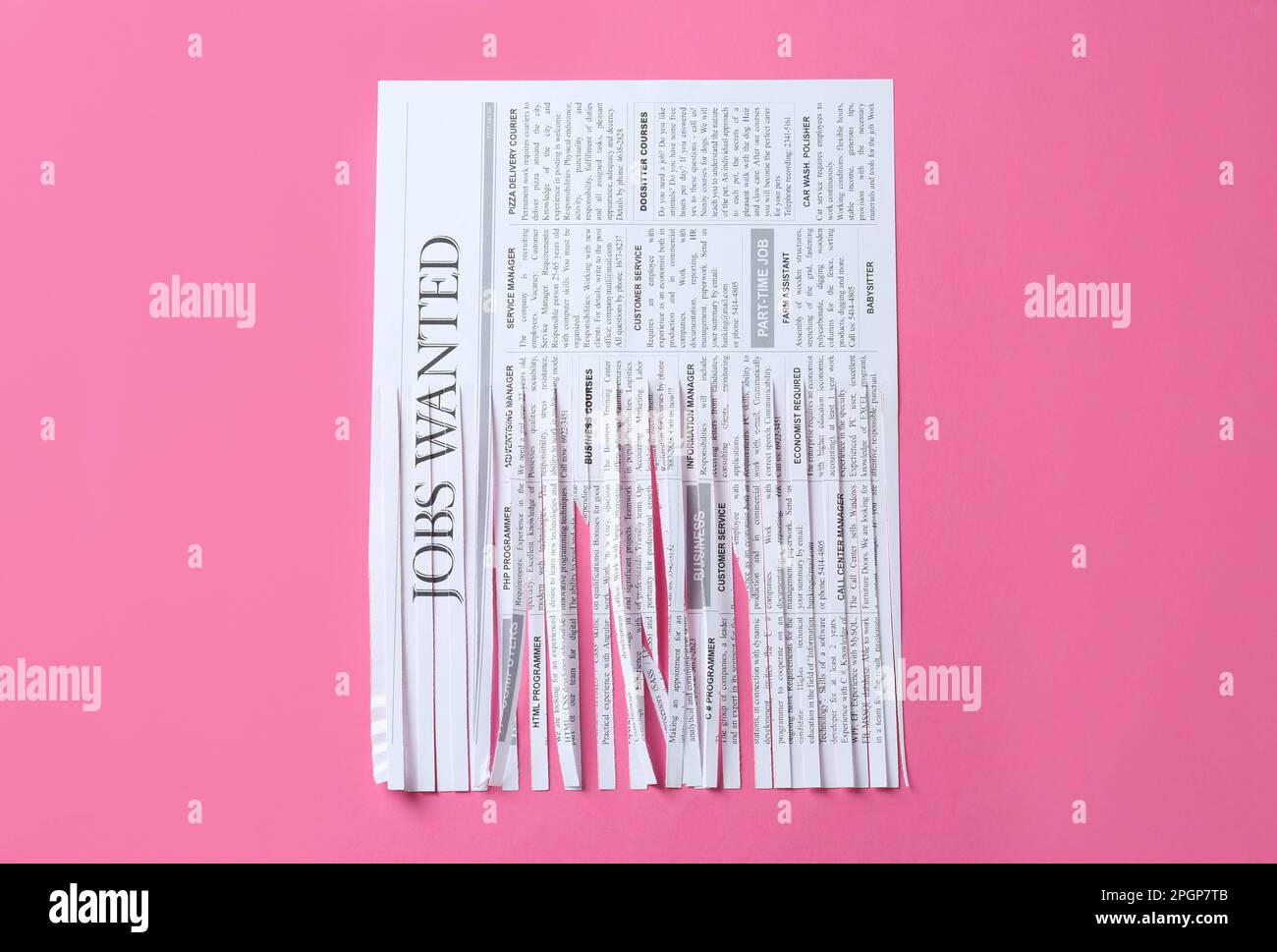 Half shredded newspaper on pink background, top view Stock Photo - Alamy