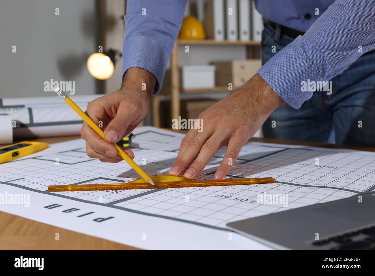 Architect working with construction drawings in office, closeup Stock ...