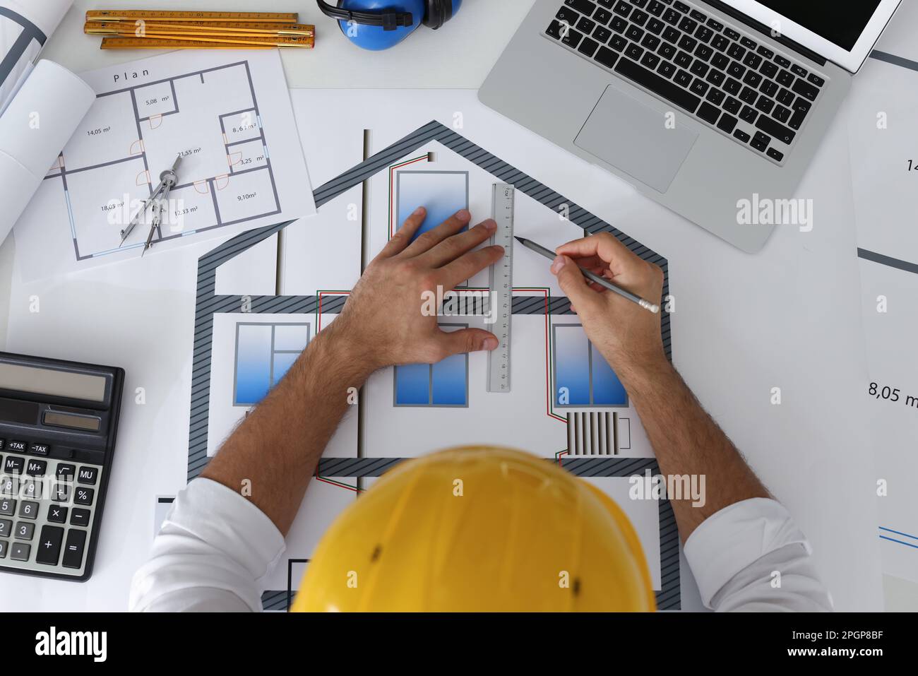 Architect working with construction drawings at white table, top view ...