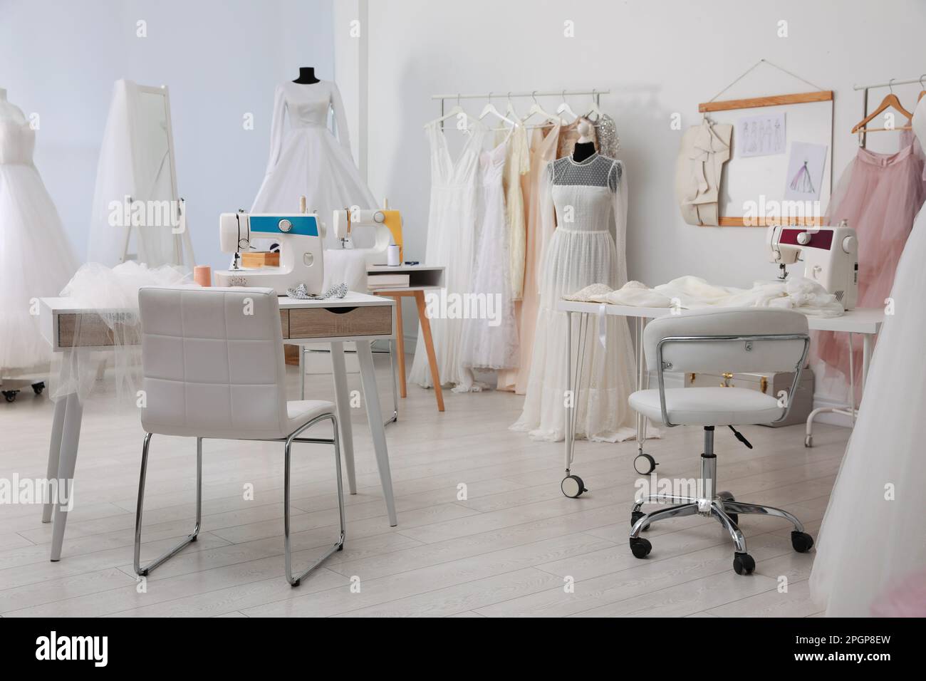 Dressmaking workshop interior with wedding dresses and equipment Stock ...