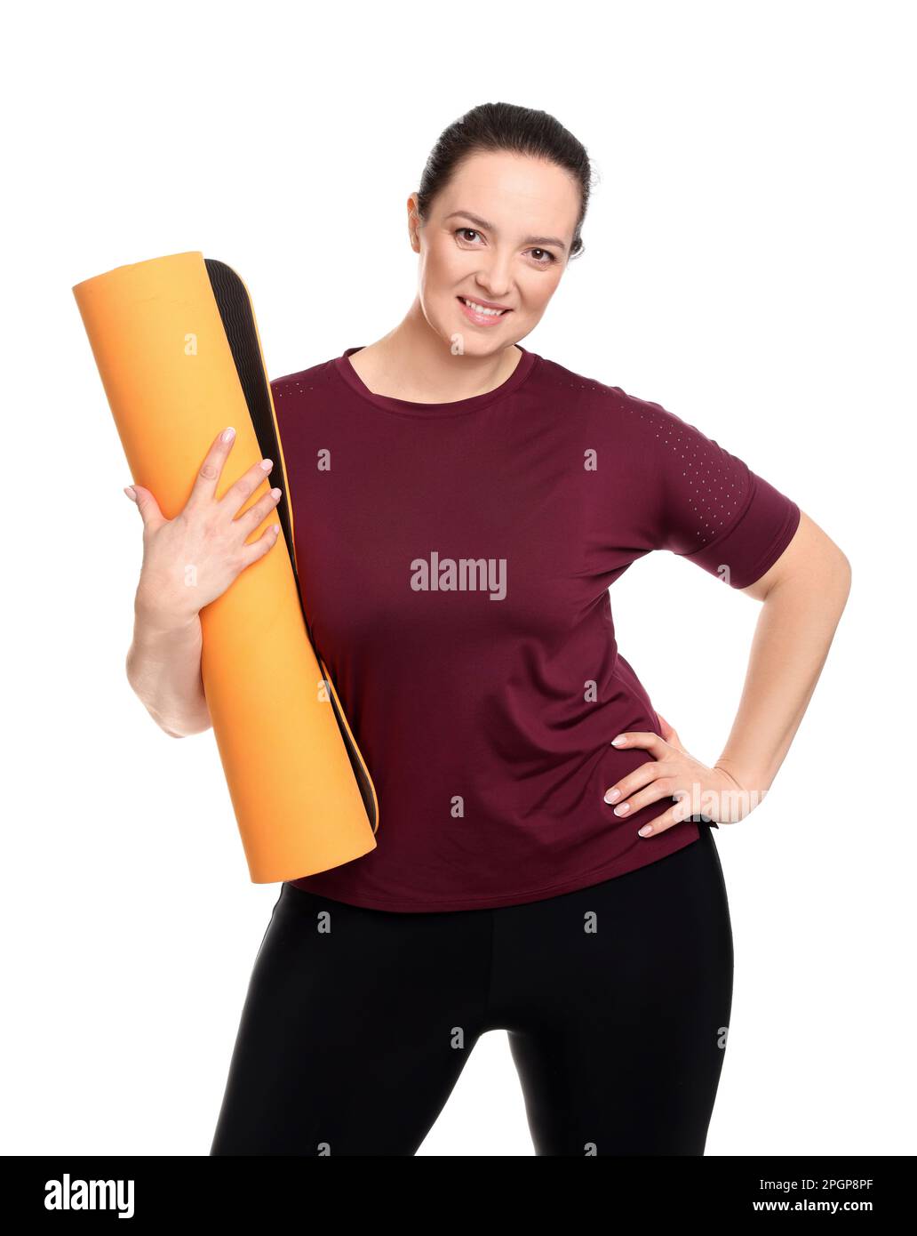 Happy overweight woman with yoga mat on white background Stock Photo ...